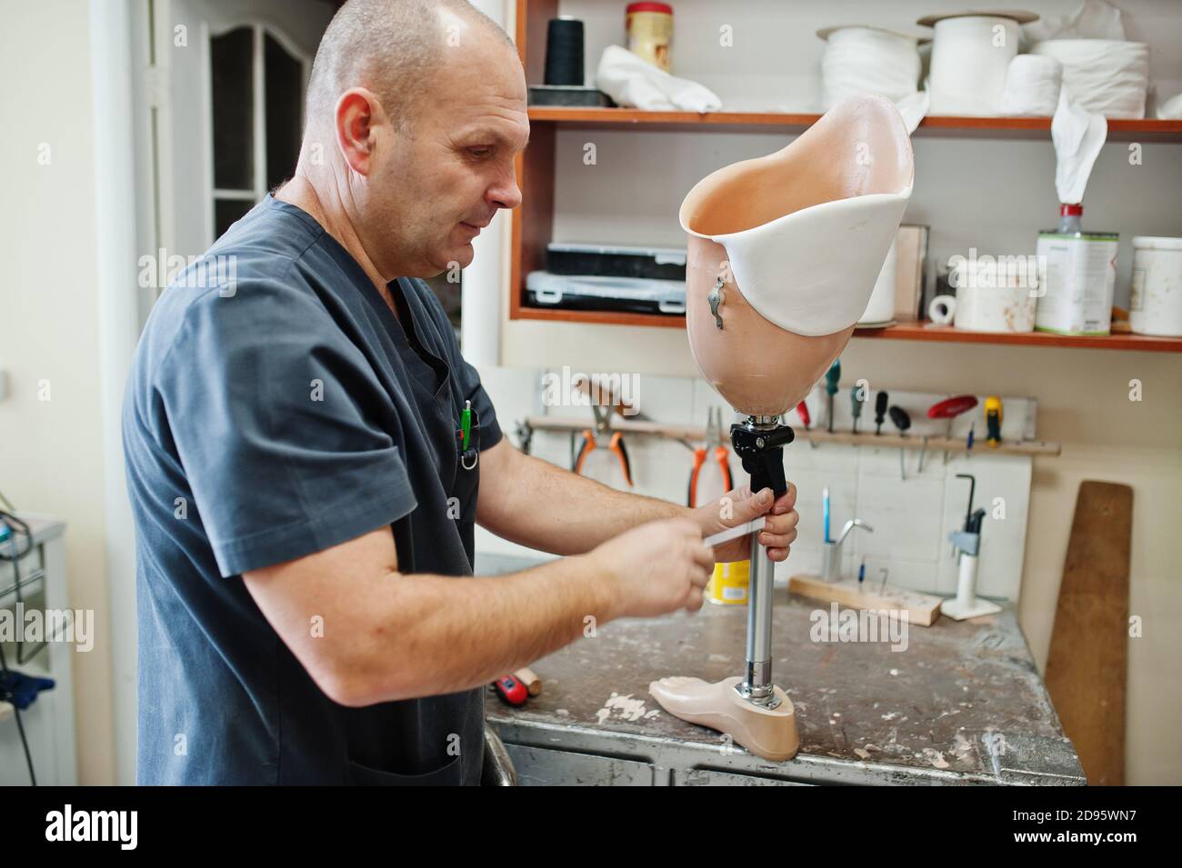 Prosthetist man making prosthetic leg while working in laboratory Stock ...