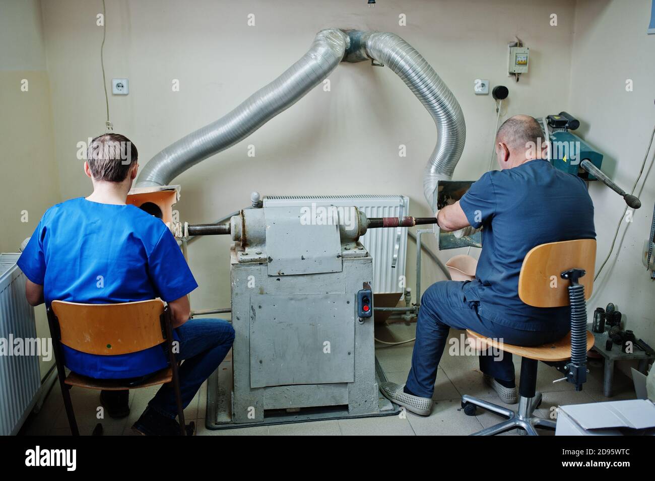 Two prosthetist man workers making prosthetic leg while working in ...