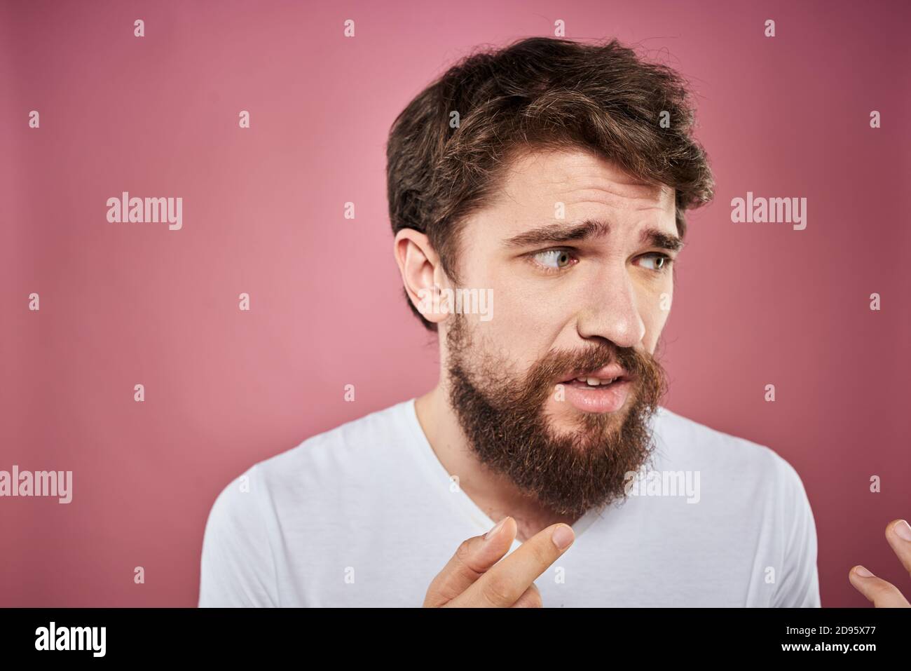 bearded man in white t-shirt emotions displeased facial expression ...