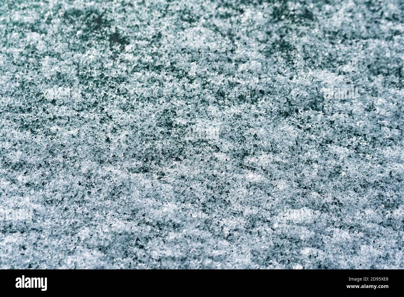 Melting snow on the car window. Close-up of ice crystals turning into ...