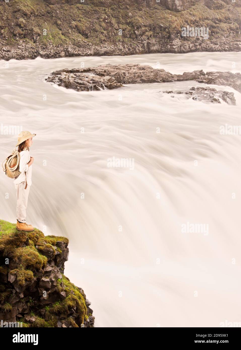 little explorer standing in front of a waterfall Stock Photo - Alamy