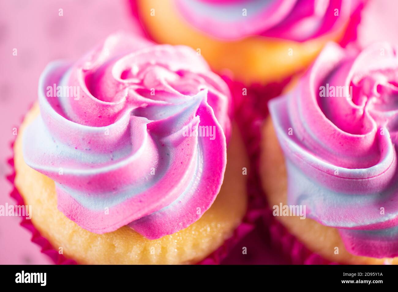 Rainbow icing and vanilla cupcake, sweet food background Stock Photo ...