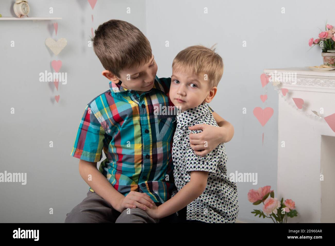 Two happy and friendly brothers hug each other, talk. Happy childhood ...