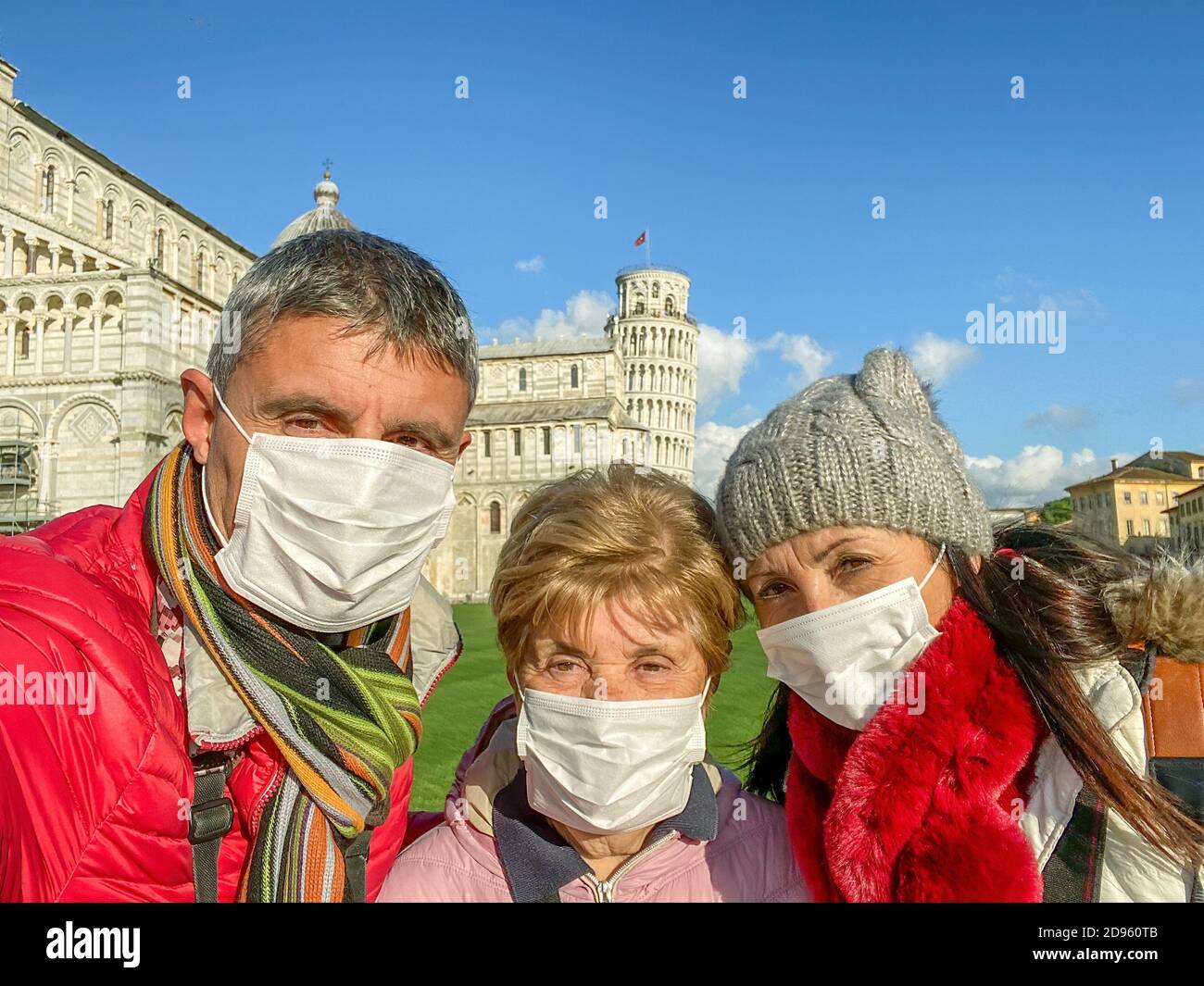 Family of three people wearing face mask visiting famous landmark Stock ...