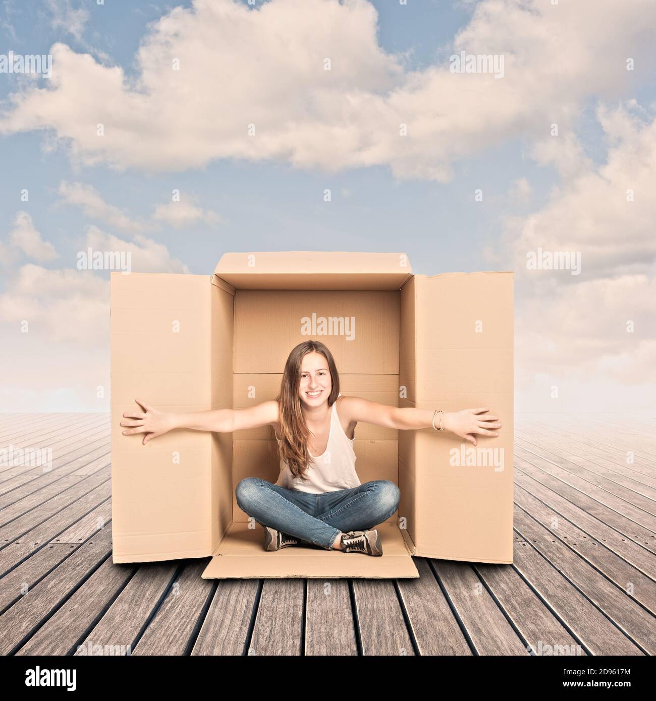 happy young woman inside a Box on a pier Stock Photo - Alamy