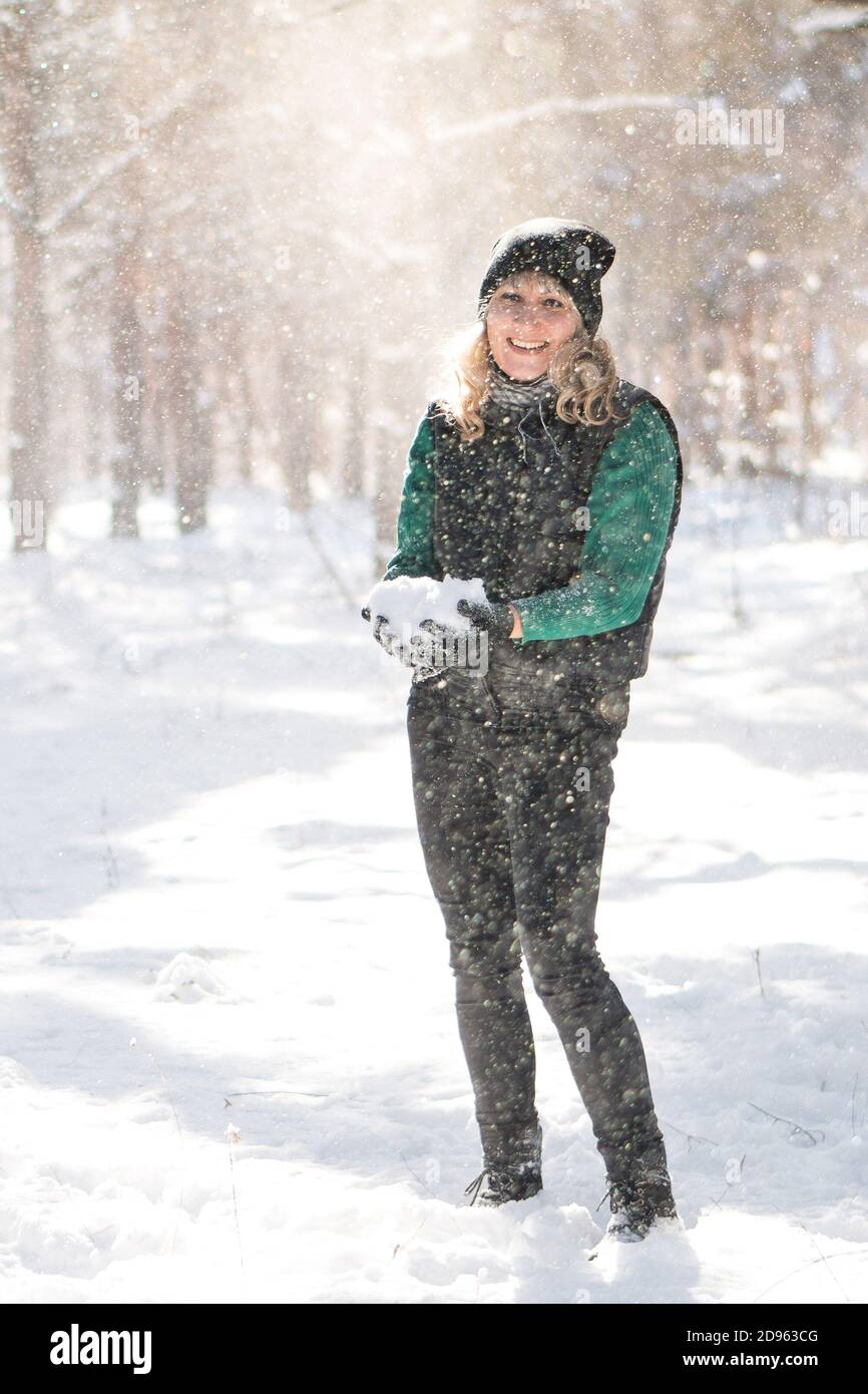 Woman in forest during blizzard. Unexpected snowstorm and snowfall ...