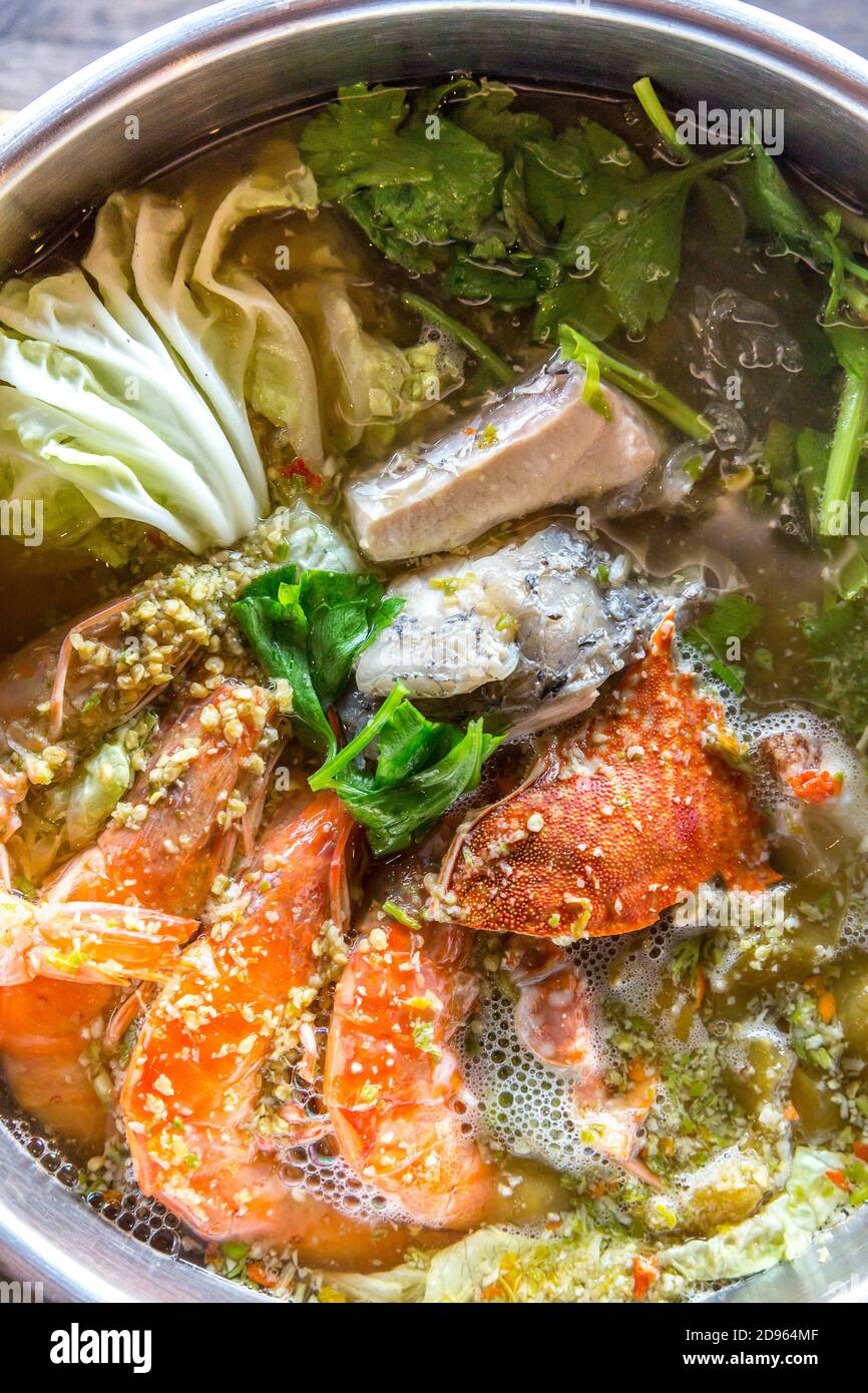 Seafood spicy hot pot crab prawn fish squid tumyum Stock Photo - Alamy