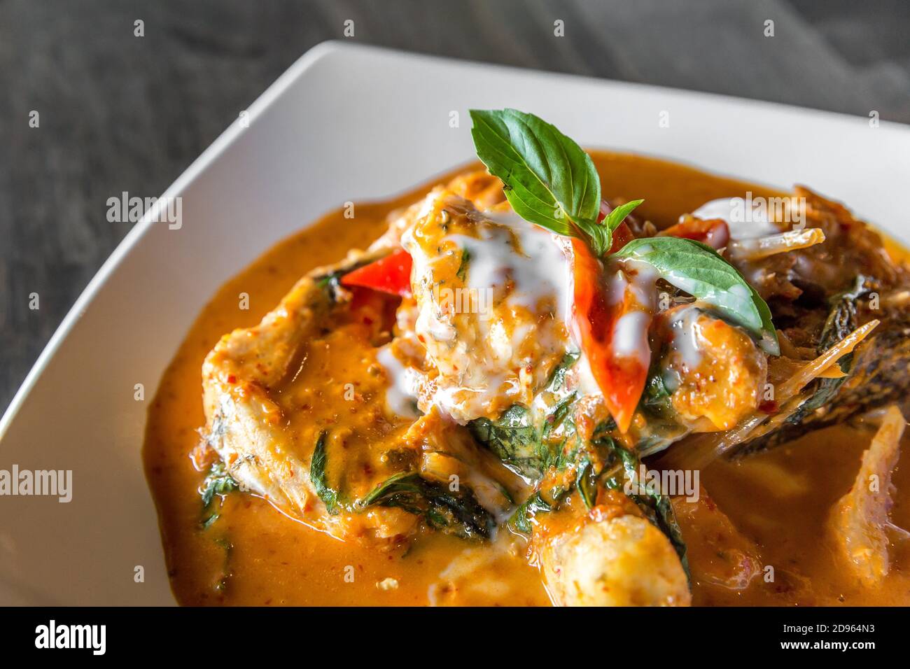Fried grouper Fish with Red Curry Paste Chu Chee Pla Stock Photo - Alamy