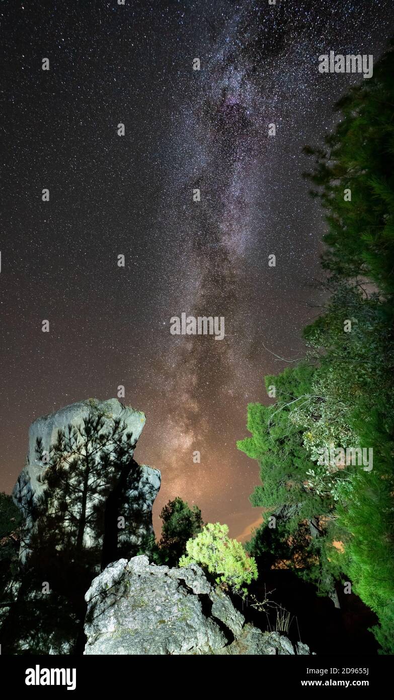 High boulder illuminated under the milky way with tree shadow Stock ...