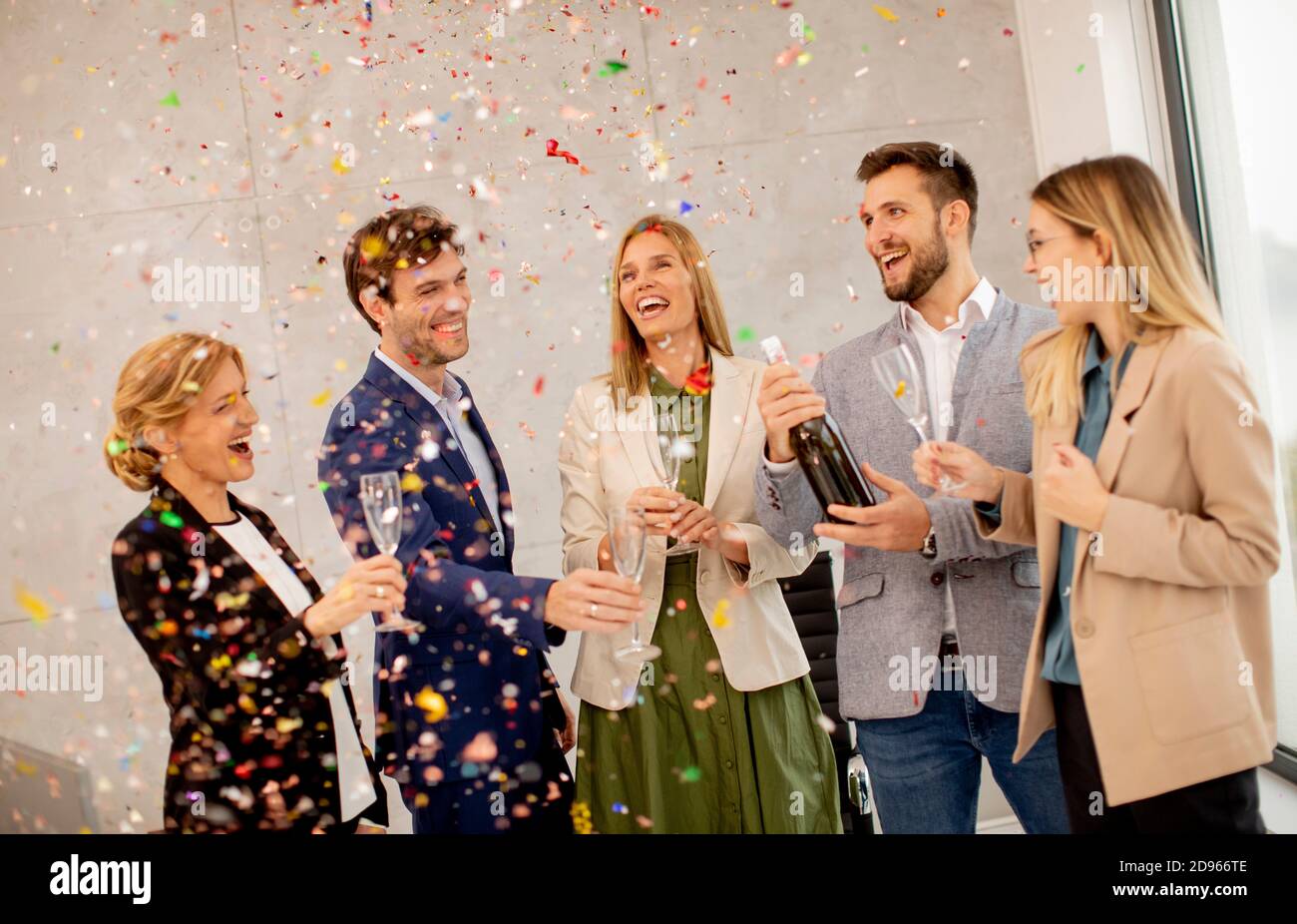 Group of excited business people celebrating and toasting with confetti ...