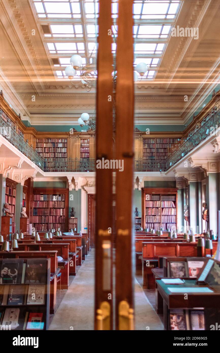Vertical shot of a library from behind a glass door Stock Photo - Alamy