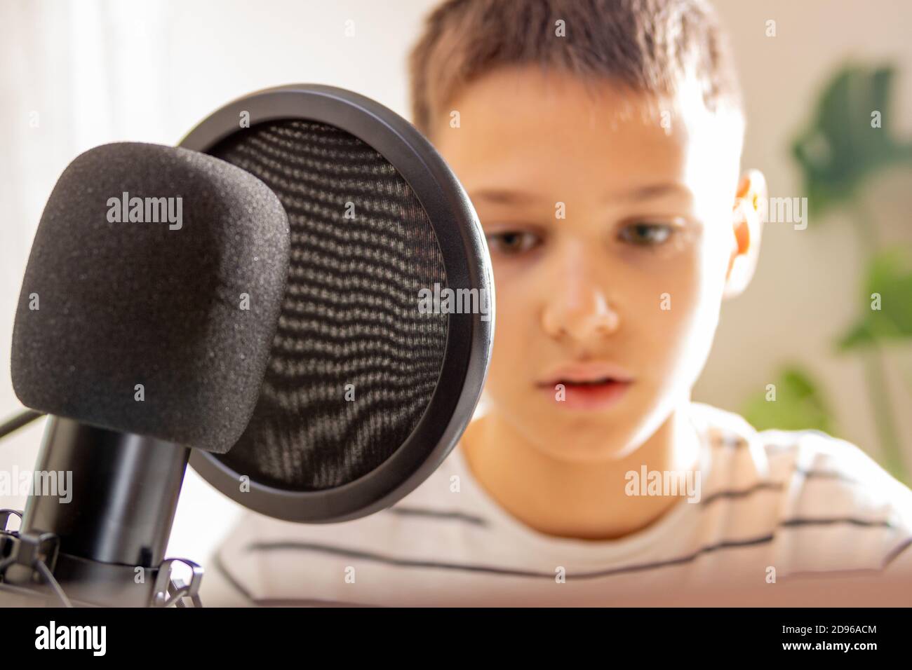 Kid talking into microphone. Techology, online learning, remote ...