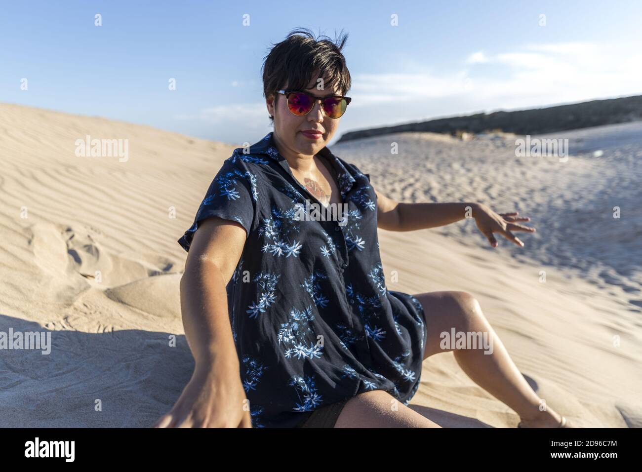 Girl sitting on sand dunes hi-res stock photography and images - Alamy