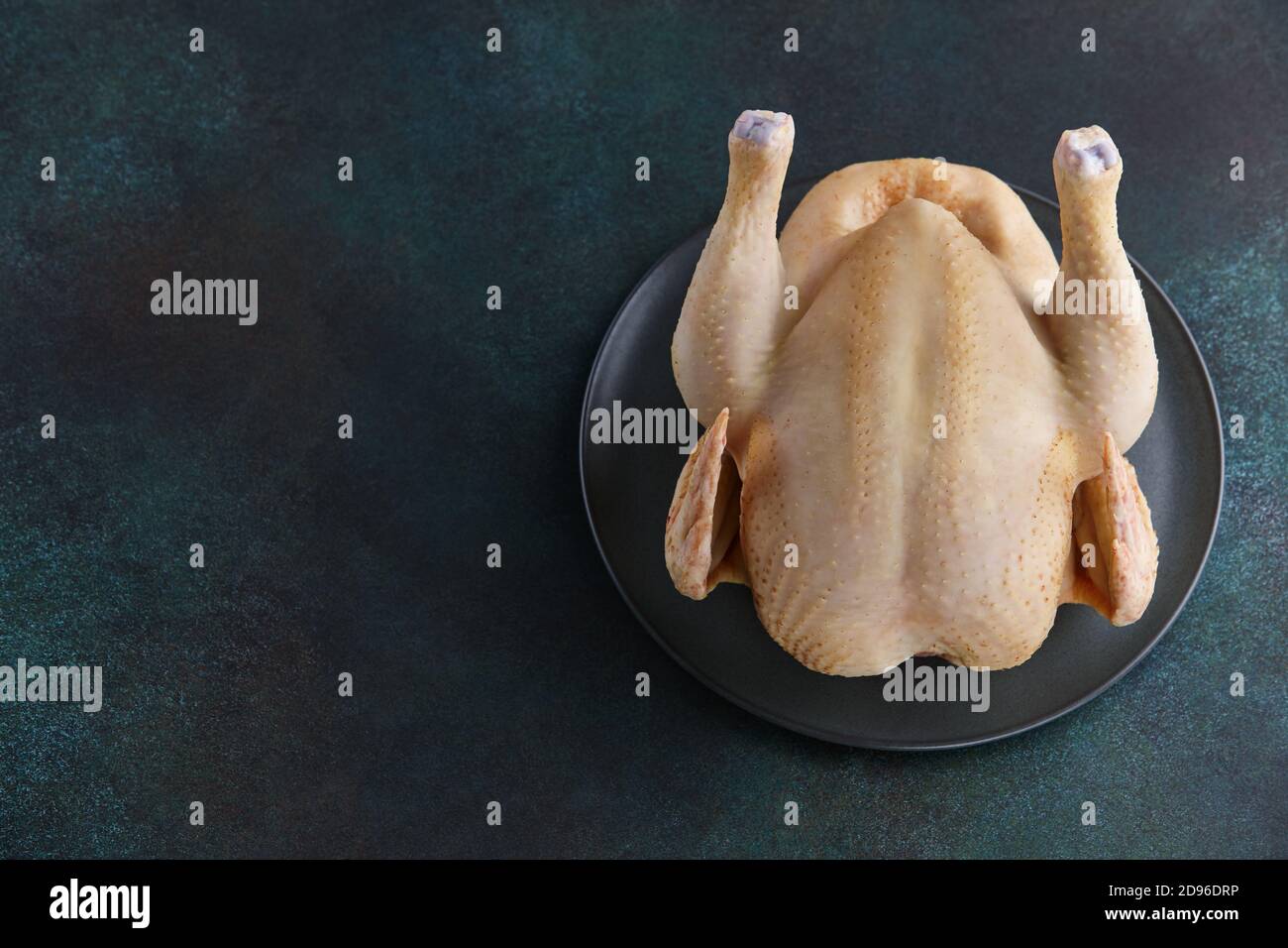 Raw turkey or chicken on textured green blue background Stock Photo - Alamy