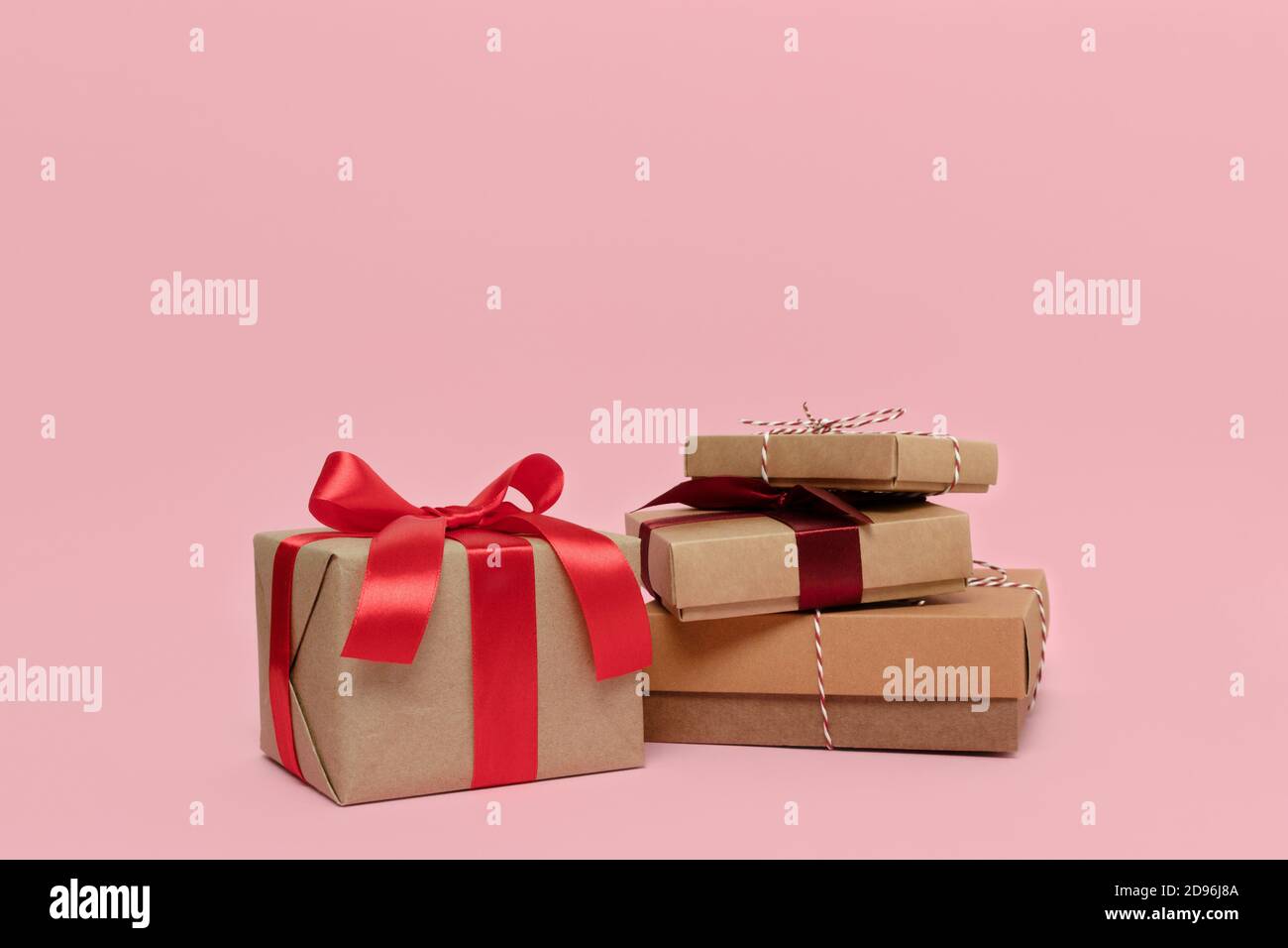 Pile of gift boxes on a pink background. Holidays composition with copy ...