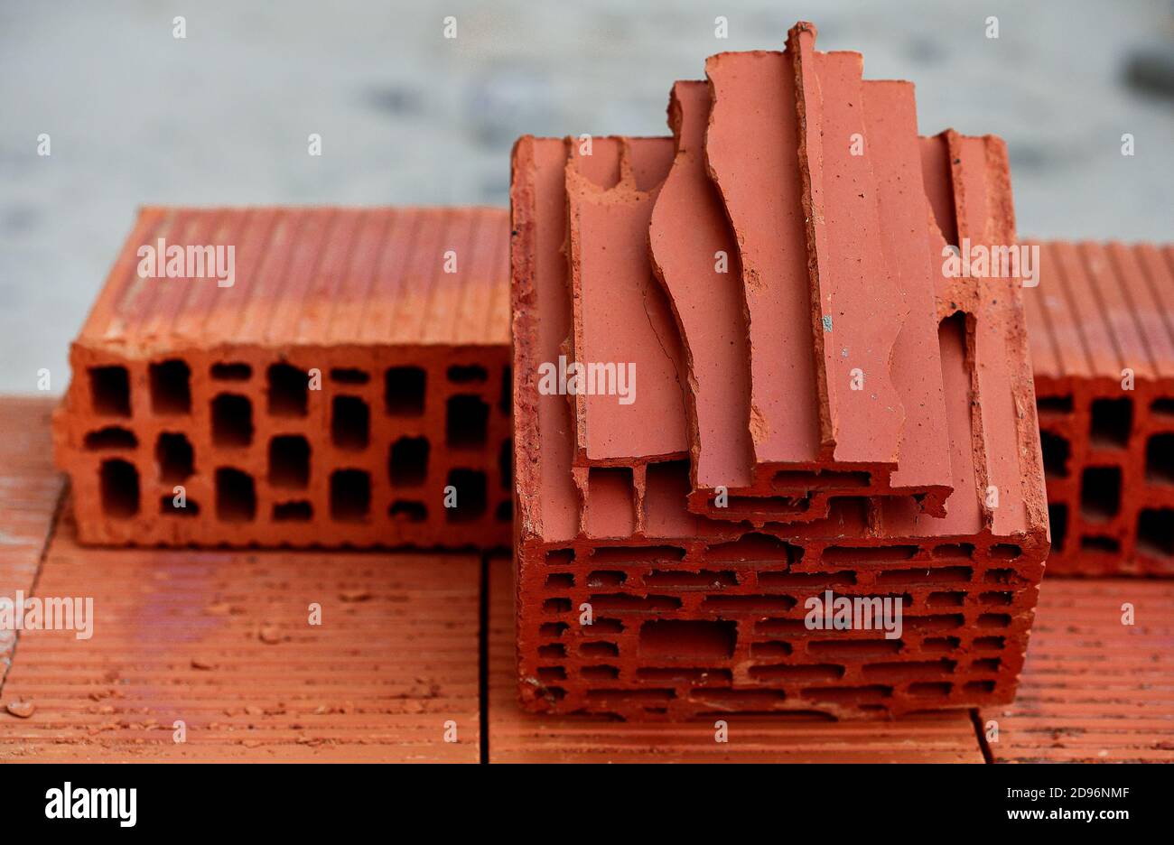 Red hollow wall brick in the context. The pile of red hollow bricks lit ...