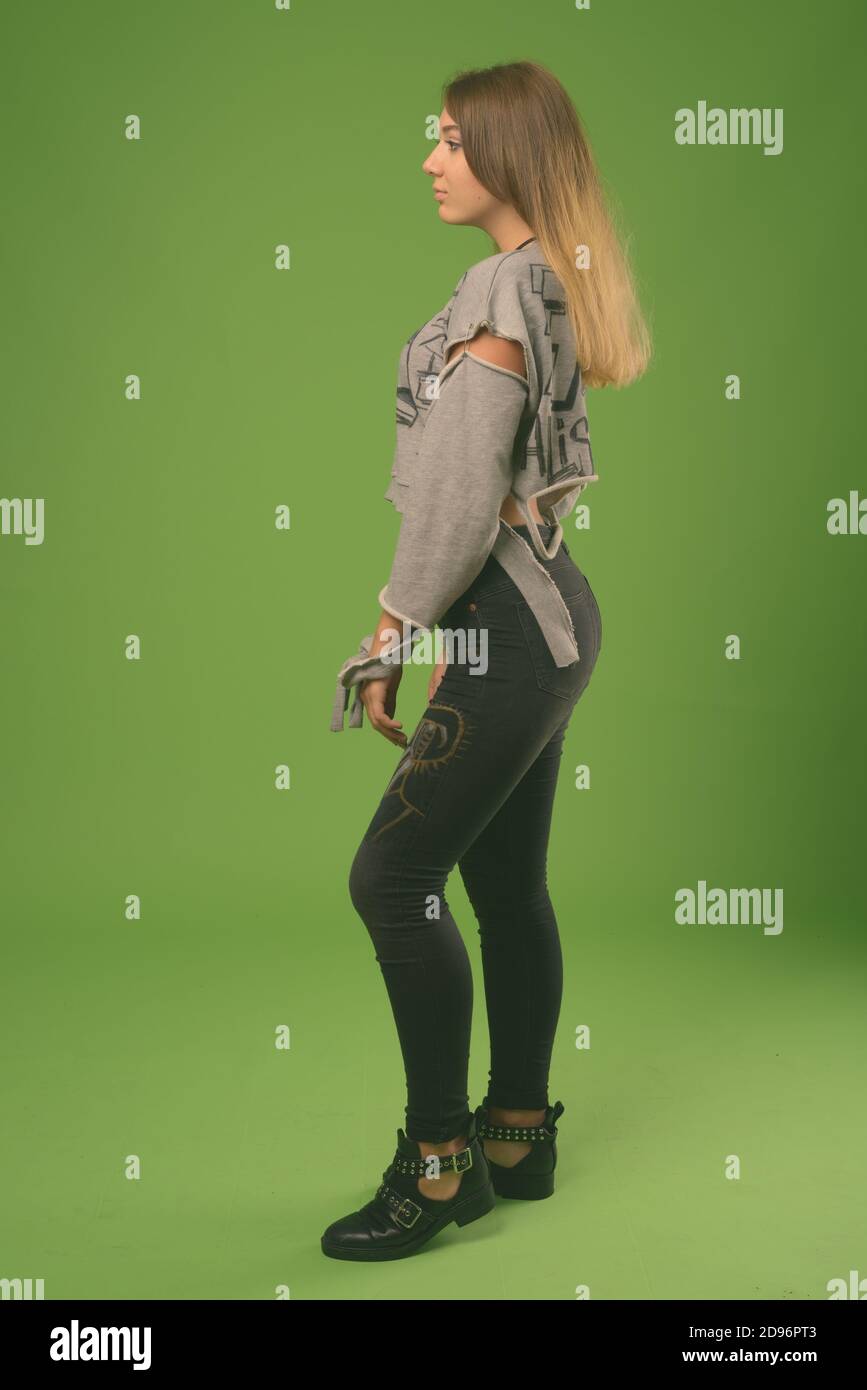 Young beautiful rebellious woman against green background Stock Photo ...