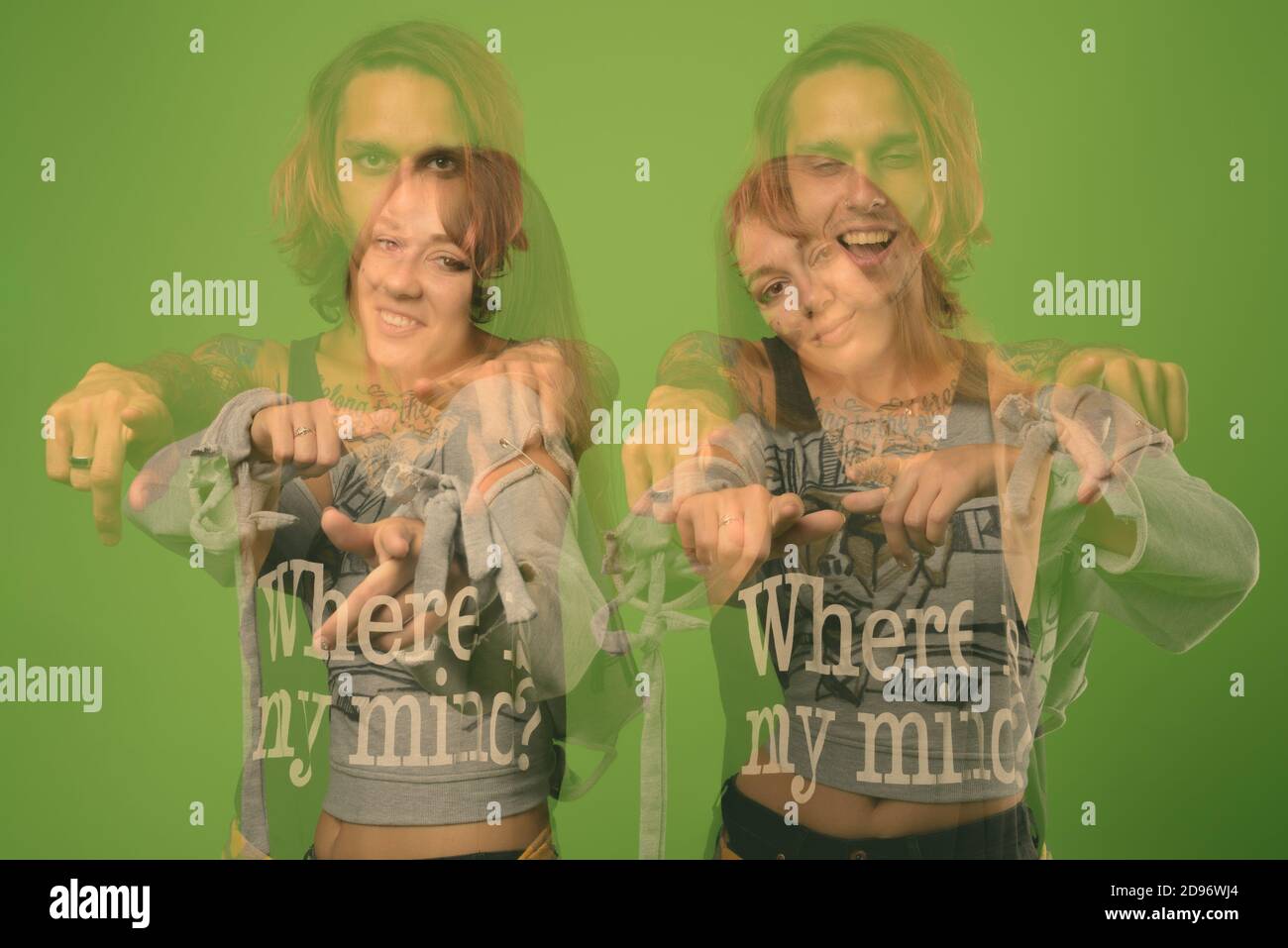 Studio shot of young rebellious man and woman together against green ...