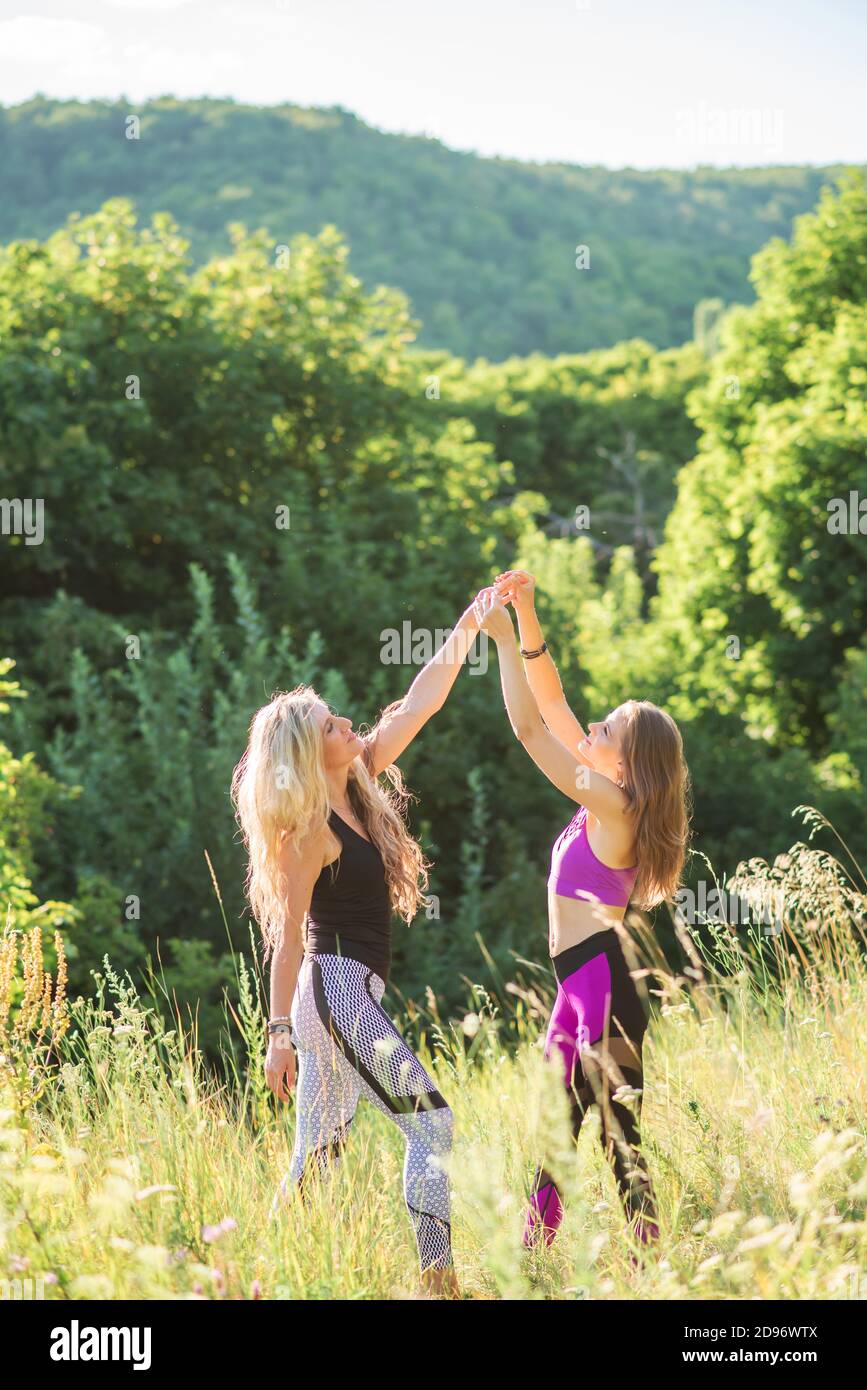 Woman yoga instructor shows a beginner how to do it right Stock Photo ...