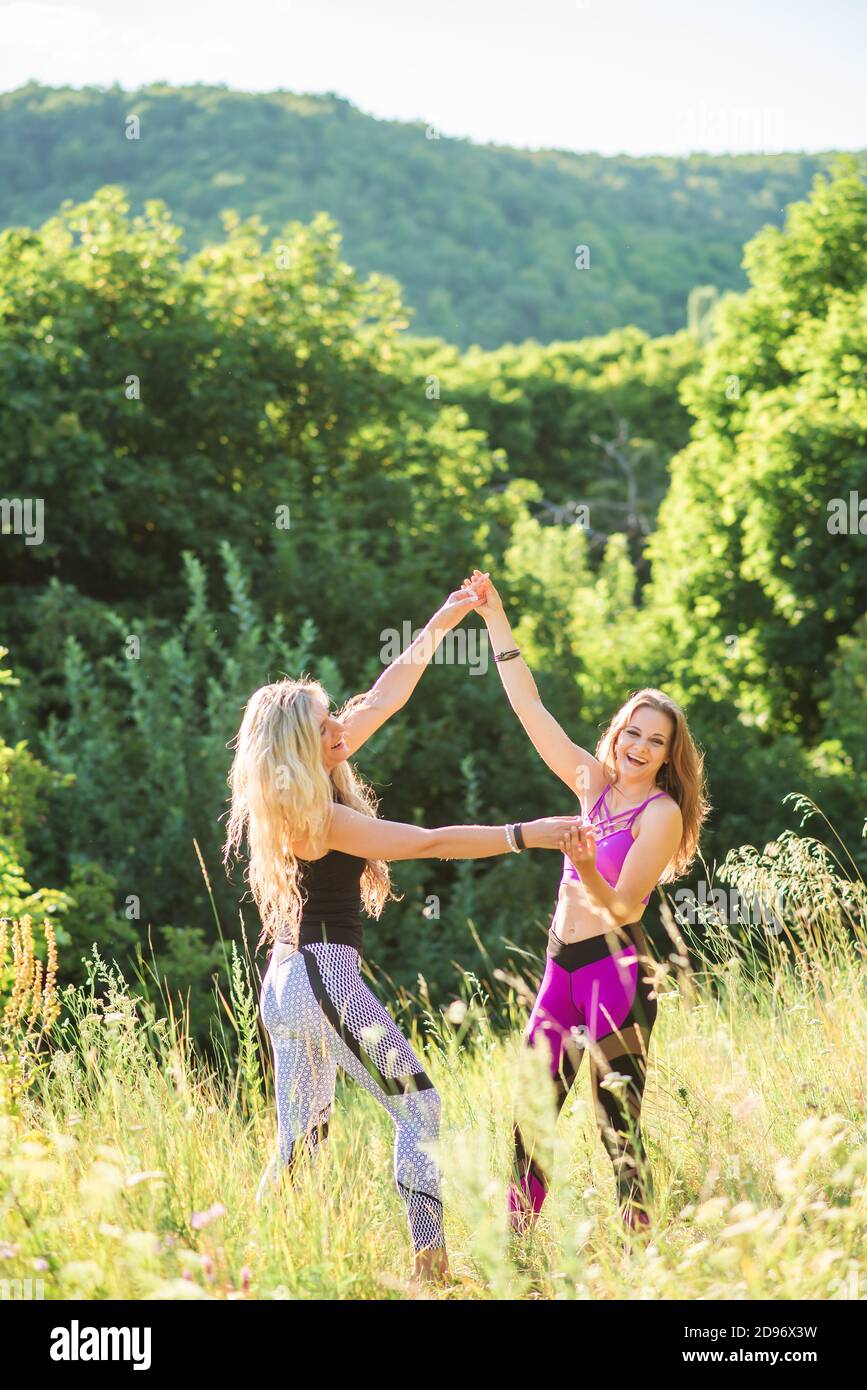 Woman yoga instructor shows a beginner how to do it right Stock Photo ...