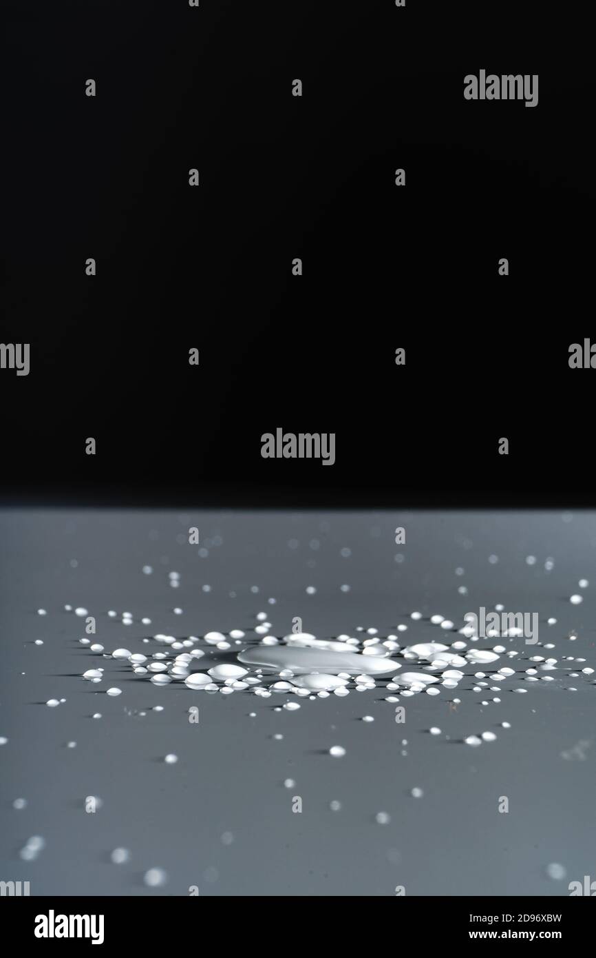Vertical shot of milk spilled on a smooth surface Stock Photo - Alamy