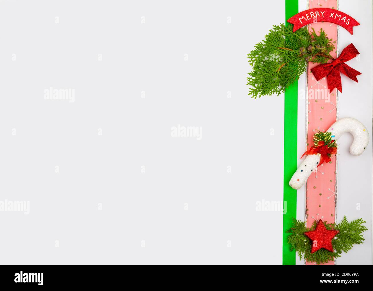 Christmas decorations placed vertically on the side of the image with ...