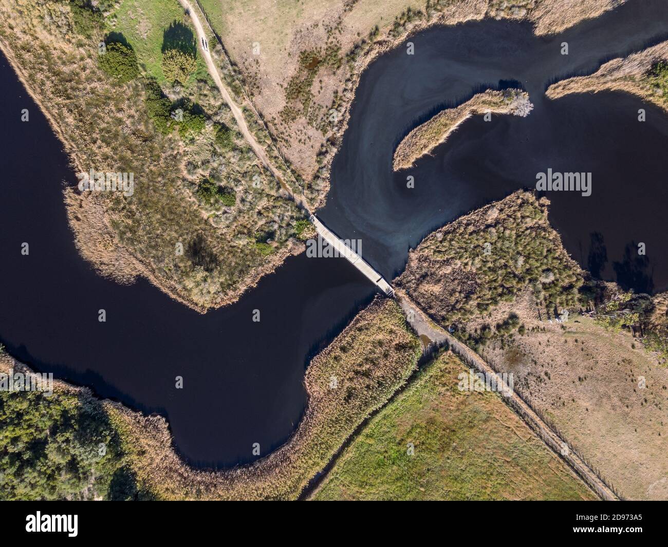 Birds-eye view of a floating wooden pontoon bridge crossing the black ...