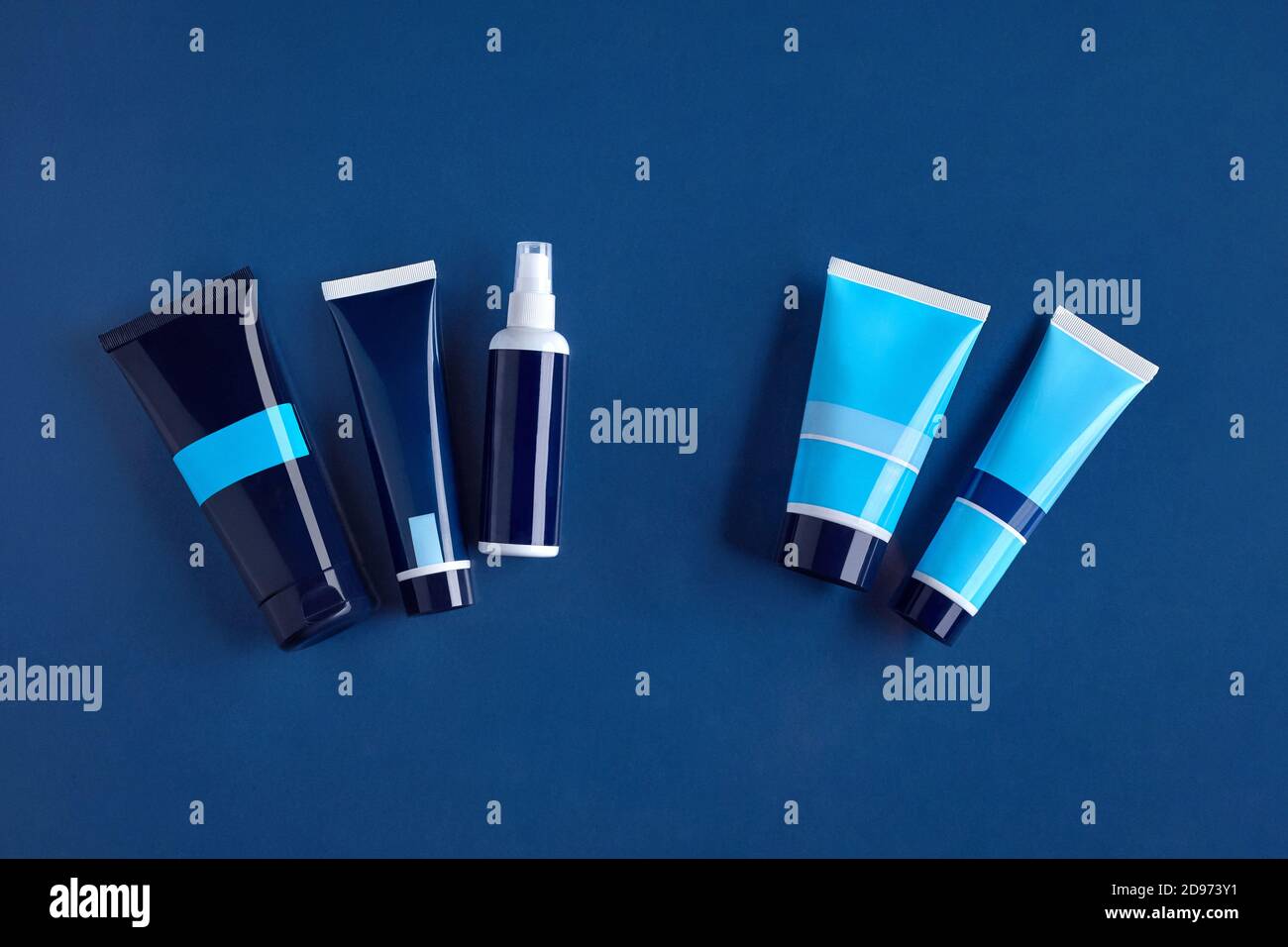 Four colorful different sized tubes and pump bottle with no logo ...