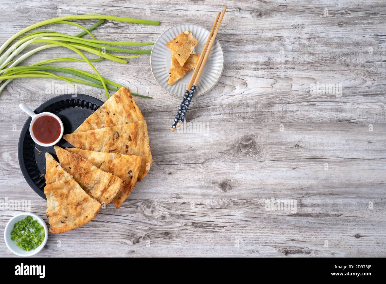 Taiwanese food - delicious flaky scallion pie pancakes on bright wooden ...