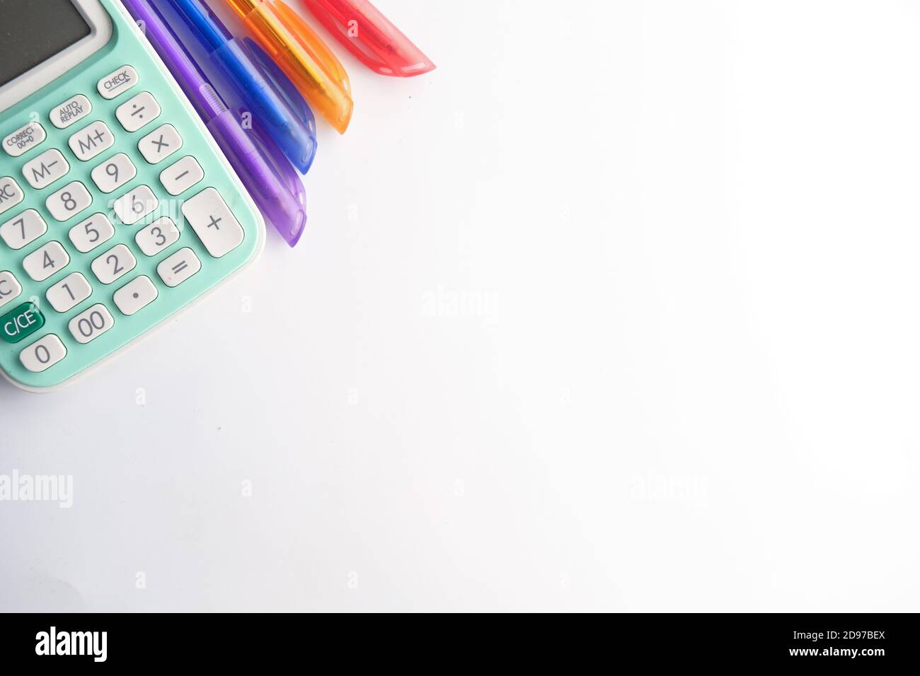 top view of calculator and colorful pens on white Stock Photo - Alamy
