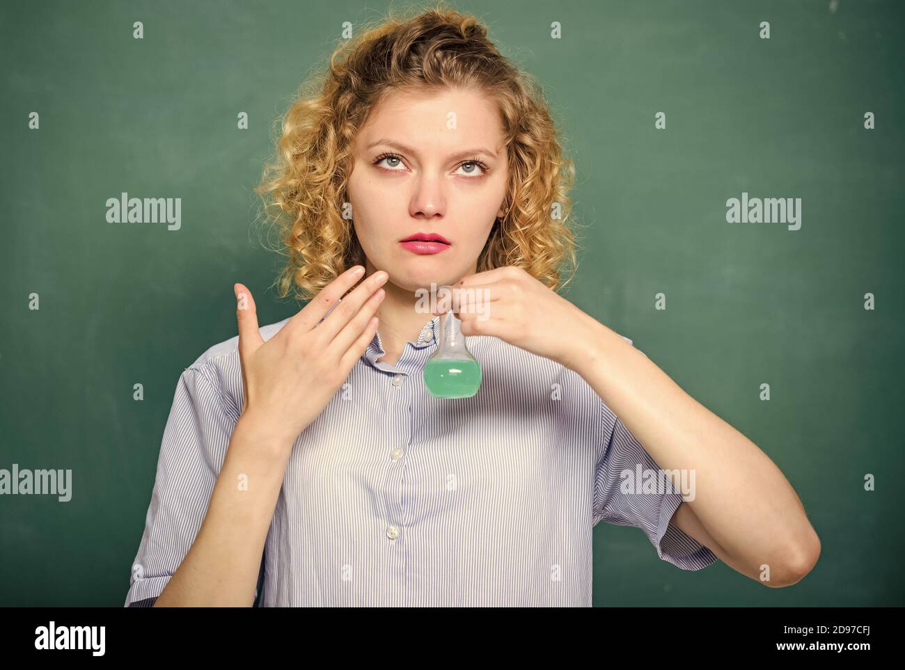 smelling sample. chemistry research results. student with beaker ...