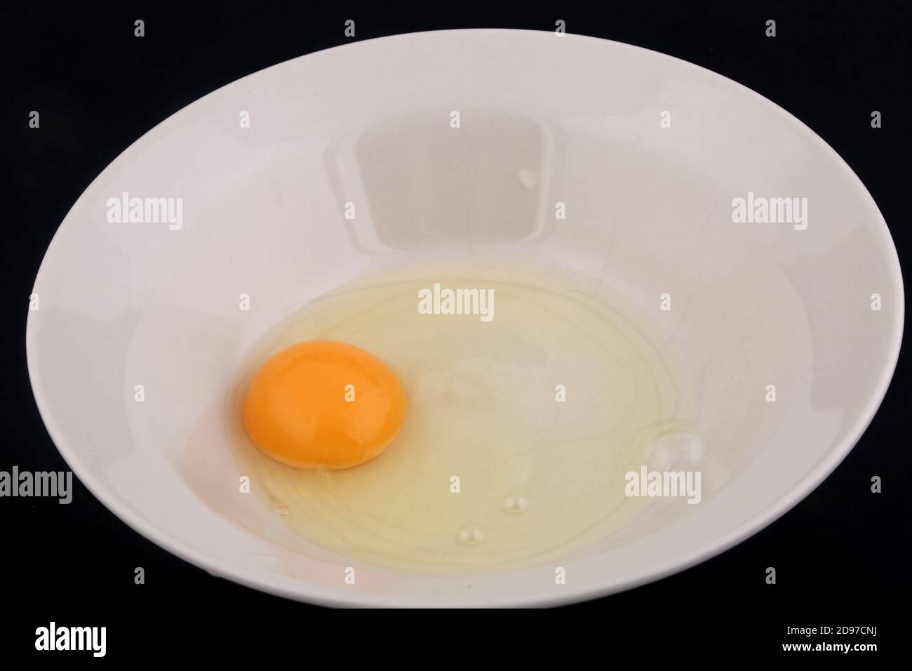 open egg with yolk ready to cook Stock Photo - Alamy