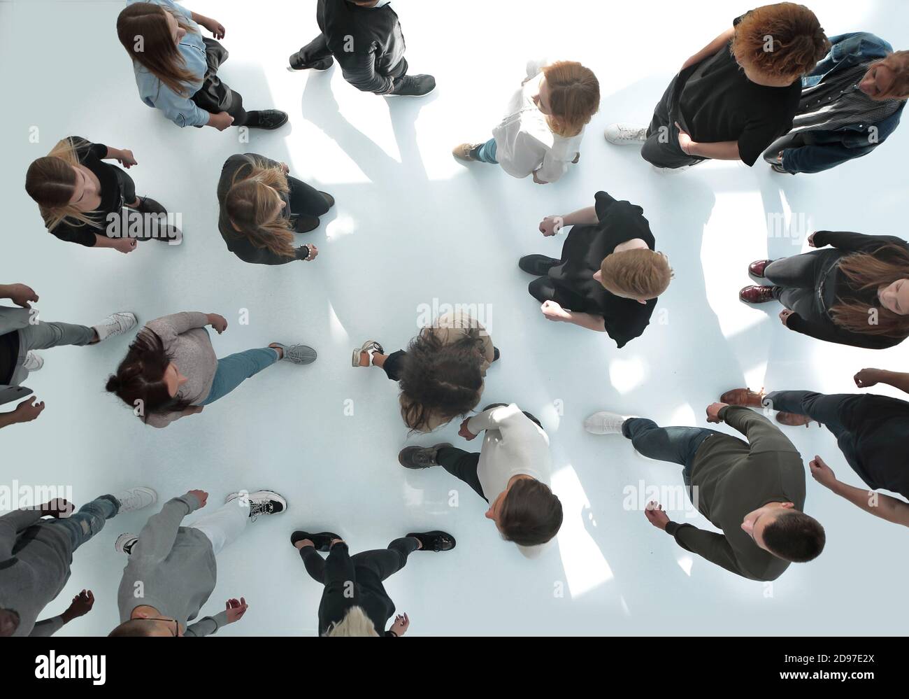 top view .groups of diverse young people moving towards each other ...
