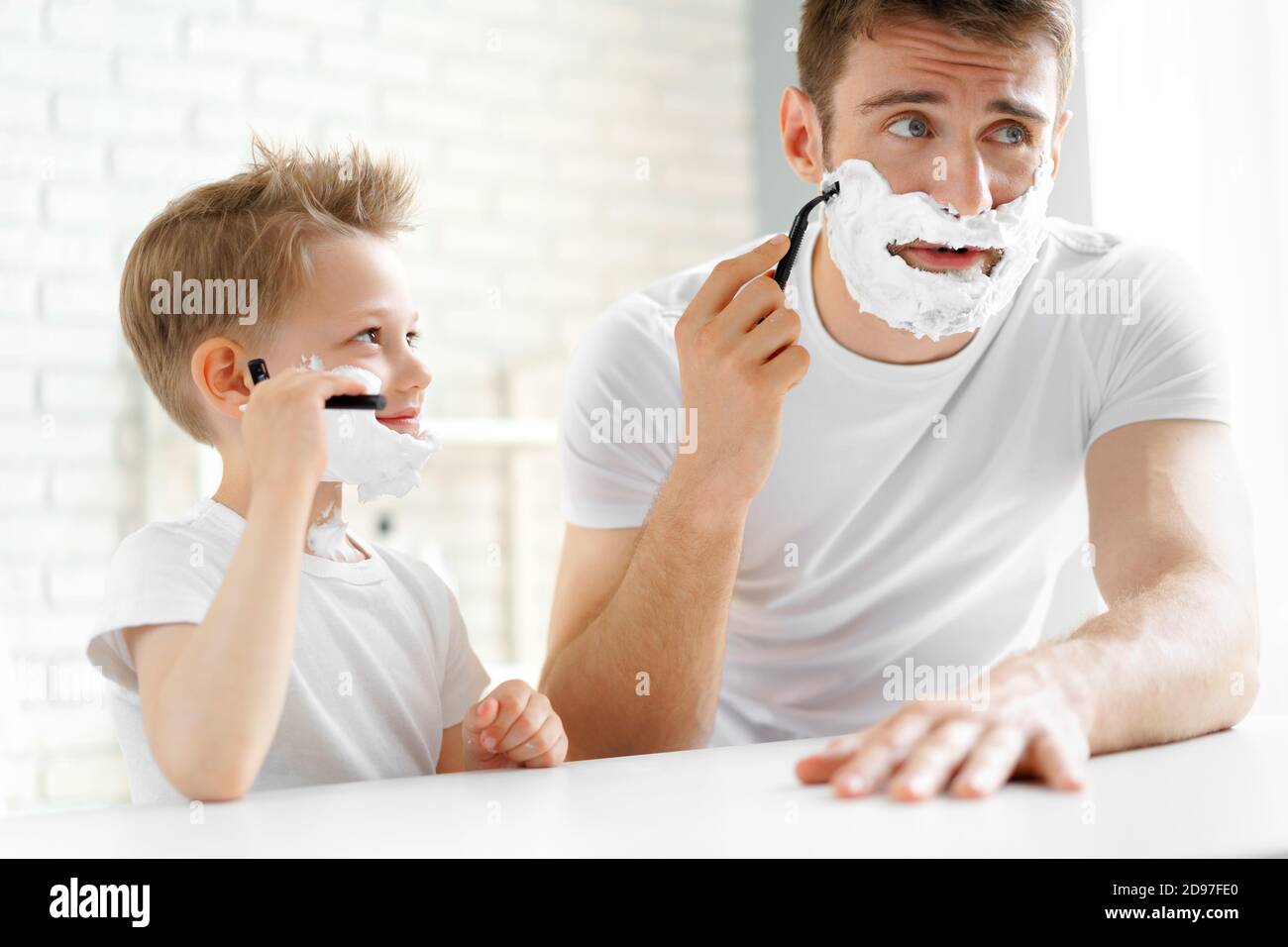 Father teaches his little son how to shave face Stock Photo - Alamy