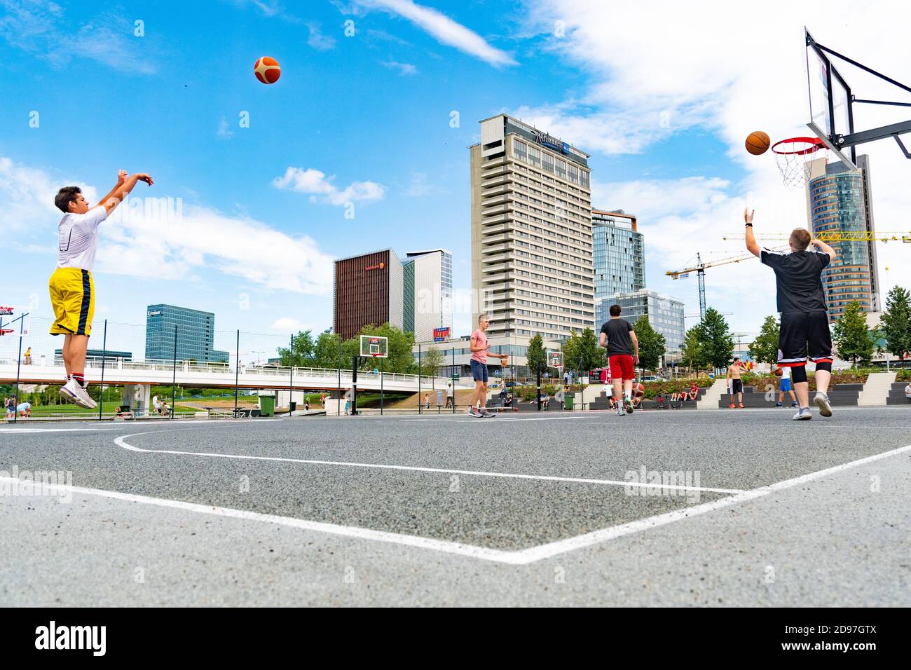 Street basketball in the city. Boys performing with city and ...