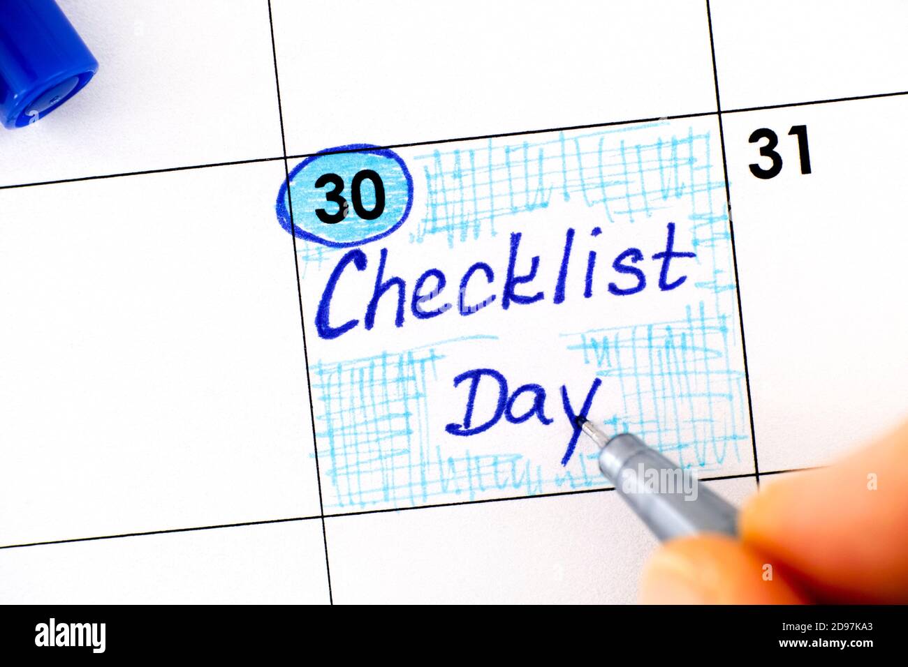 Woman fingers with pen writing reminder Checklist Day in calendar ...