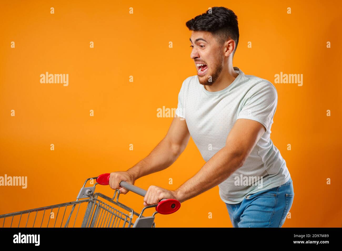 Funny crazy man rushing with shopping trolley to sale Stock Photo - Alamy