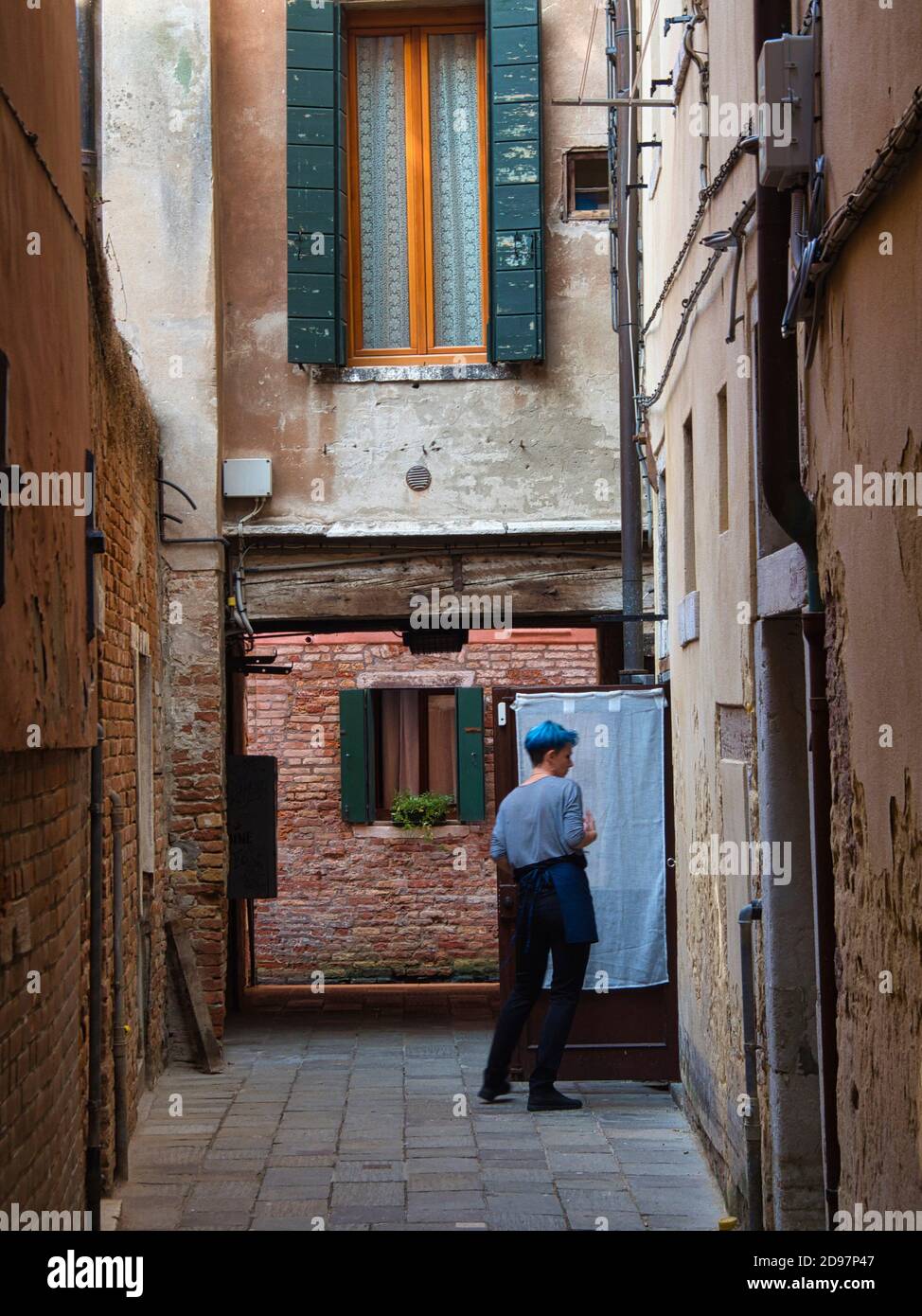 waitress going in back door of restaurant in narrow alleyway, Venice ...