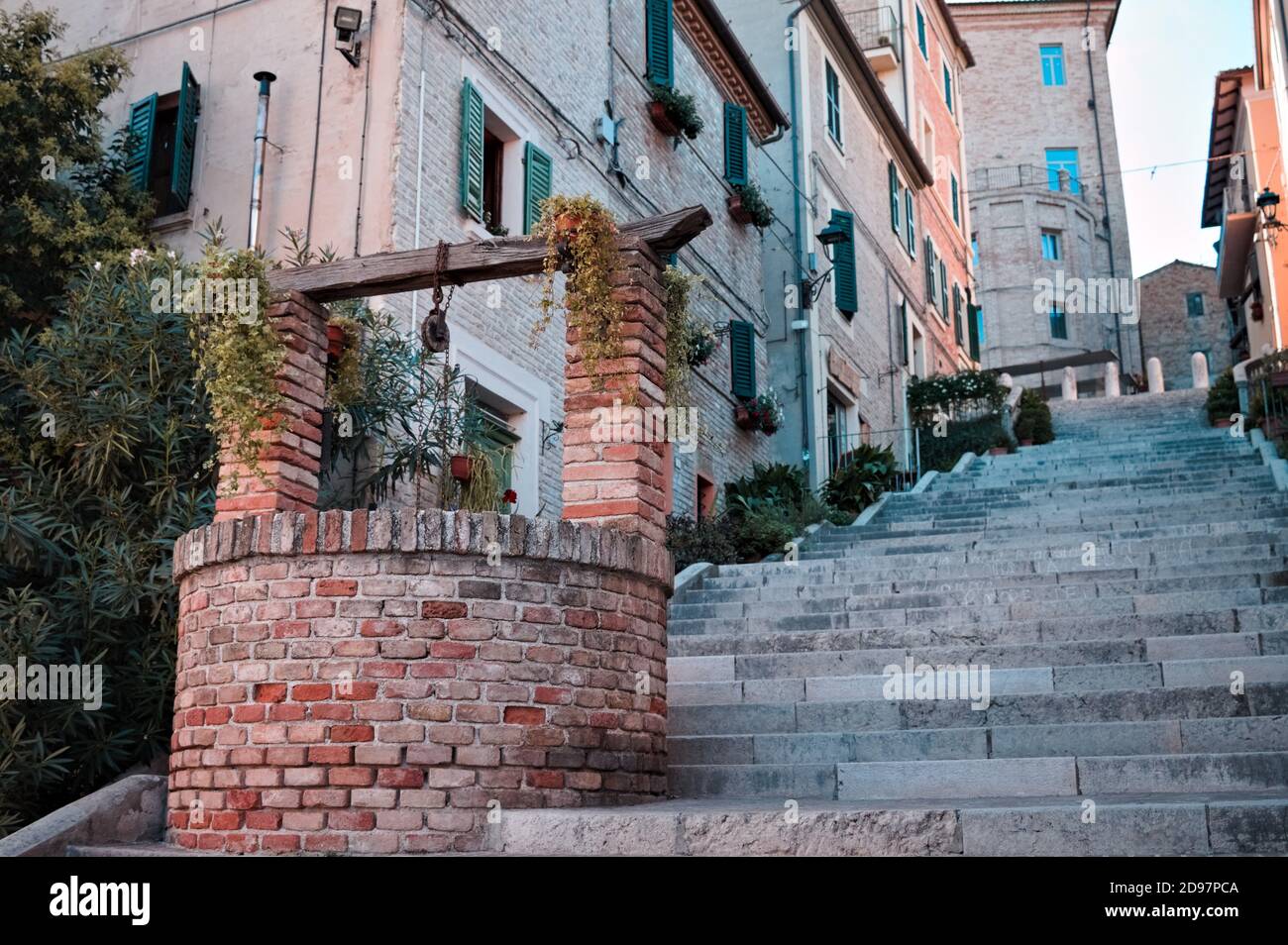 A medieval brick water well in the middle of a staircase in an ancient ...