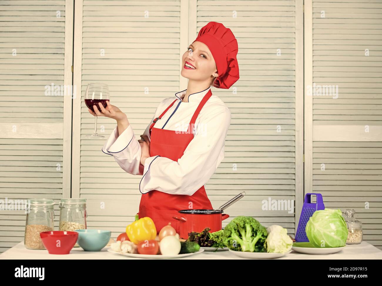 Housekeeping and culinary. Housewife prepare meal with wine. Housewife ...