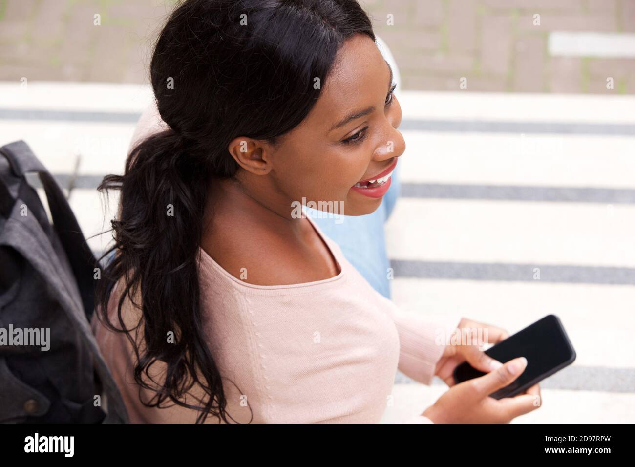 Woman holding mobile phone from behind hi-res stock photography and ...