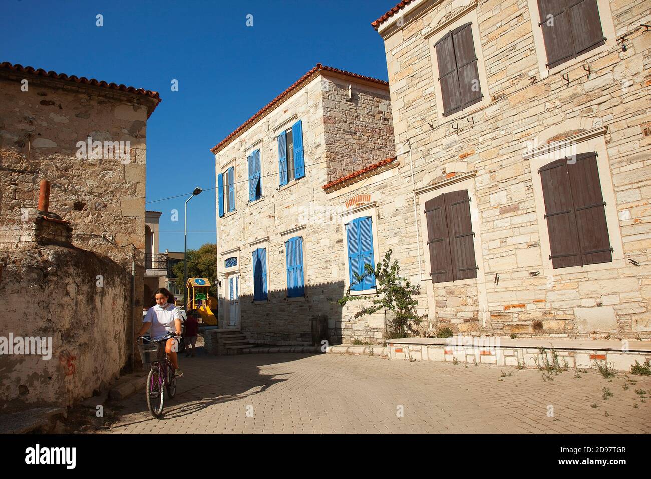Cyclist in front of the traditional house at Smaller Sea-Küçükdeniz ...
