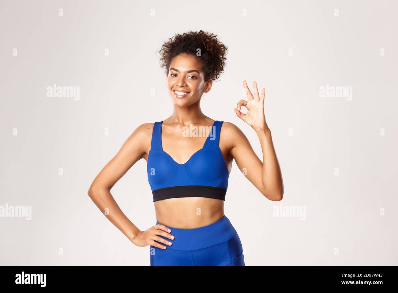 Waist-up of pleased african-american healthy fitness woman, showing ...