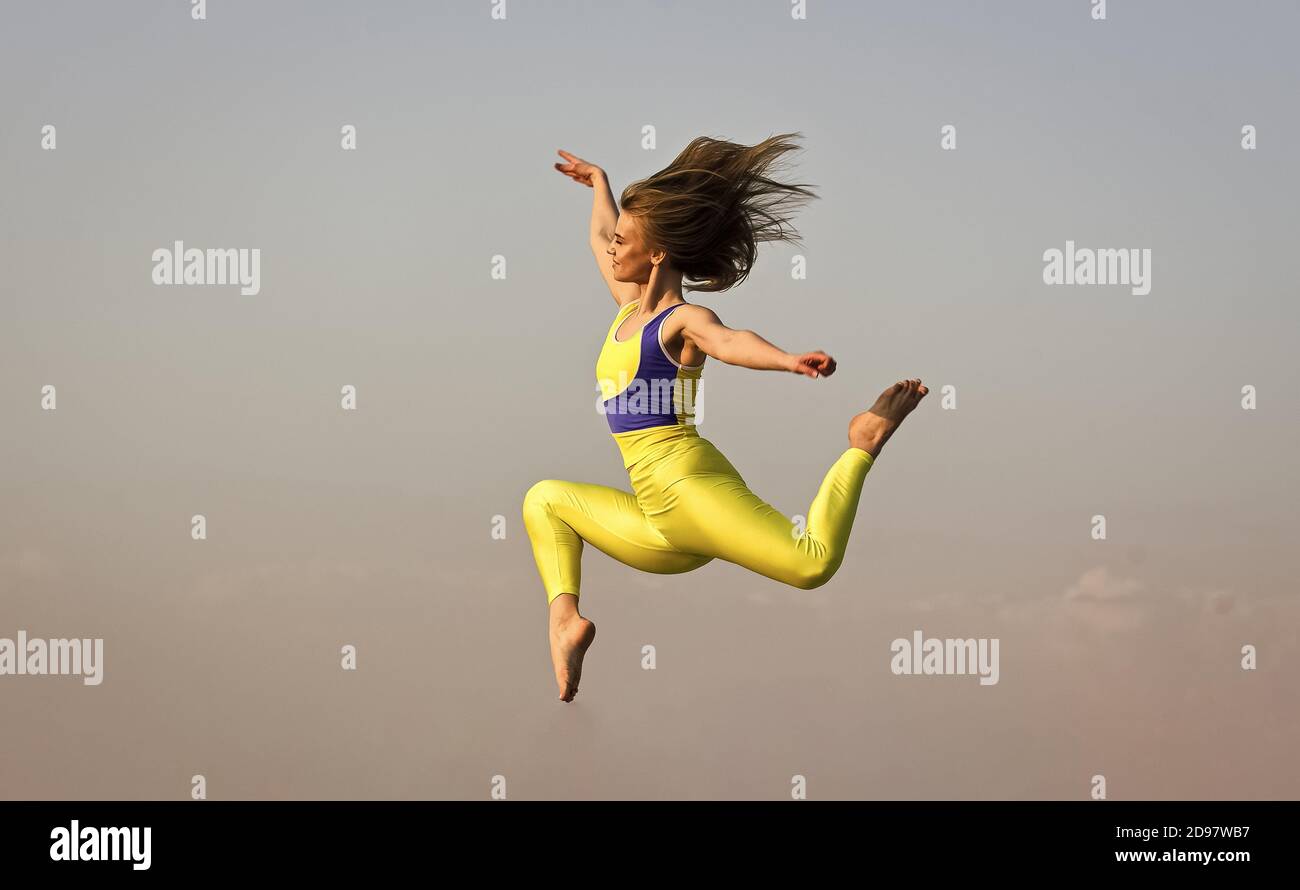 girl jumping high. sport in motion. full of energy. Attractive young ...
