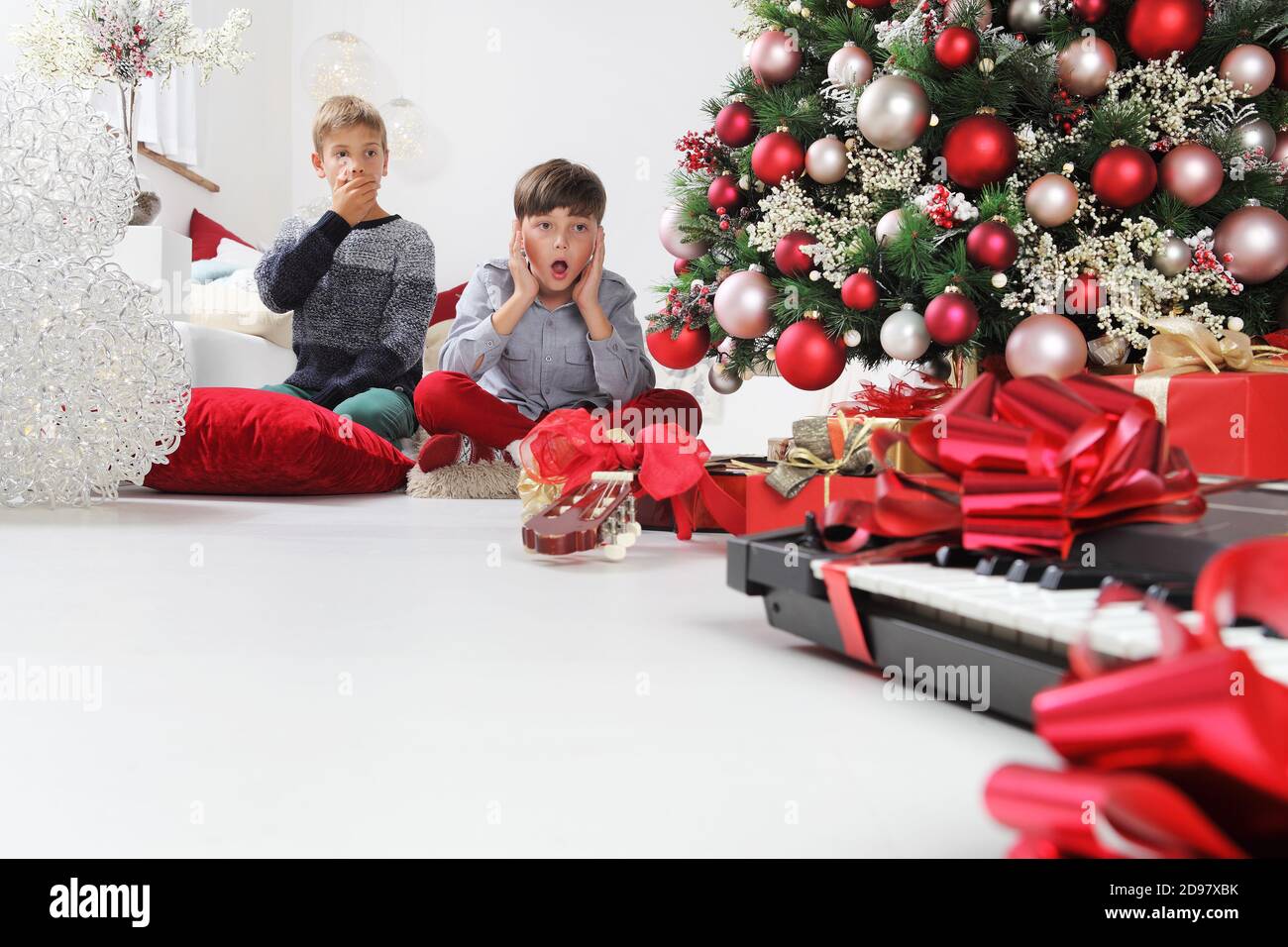 merry christmas and happy holidays, amazed children near the christmas ...