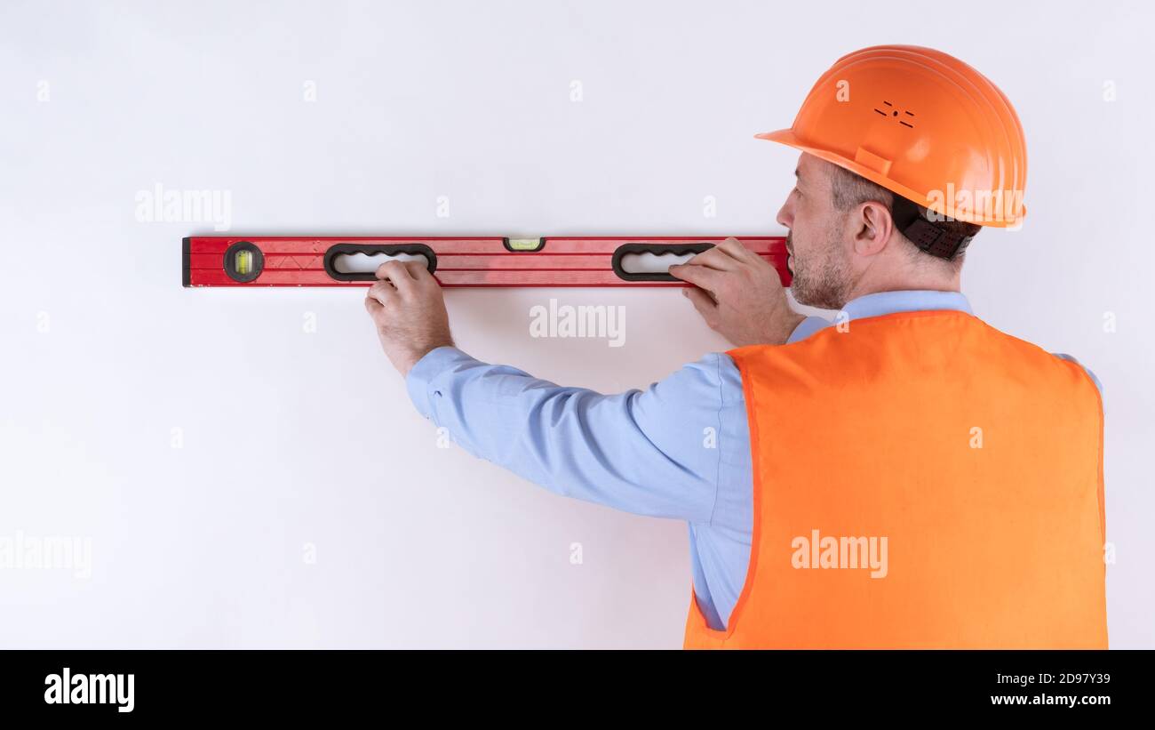 Housebuilder Using Building Level Standing Back To Camera, White ...