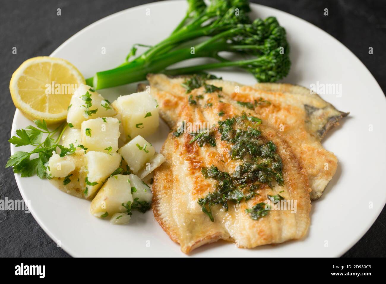 Two cooked plaice fillets from a plaice, Pleuronectes platessa, that ...