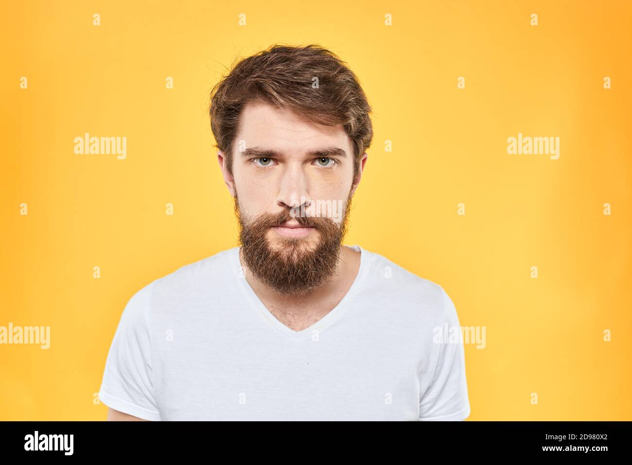 Man in white t-shirt emotions studio gestures with hands displeased ...