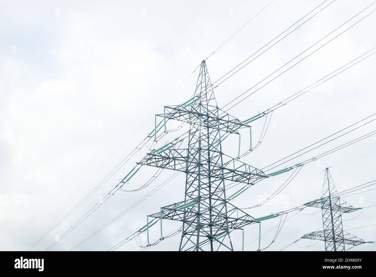 Pylon or transmission tower against a stormy sky. Burst of sunshine ...