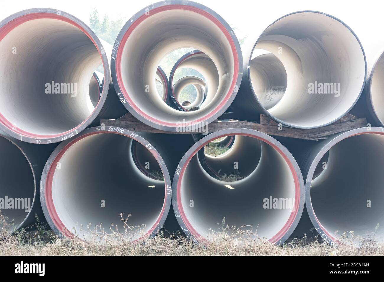 front circular view of ductile iron pipes stocked in open space go-down ...
